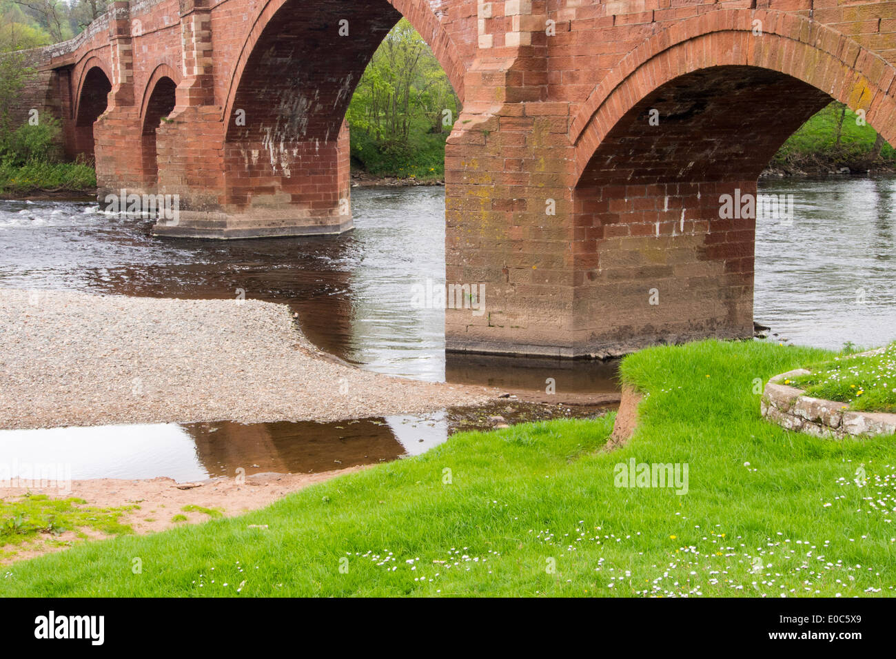 An old red sandstone bridge across the river Eden at Kirkoswold ...