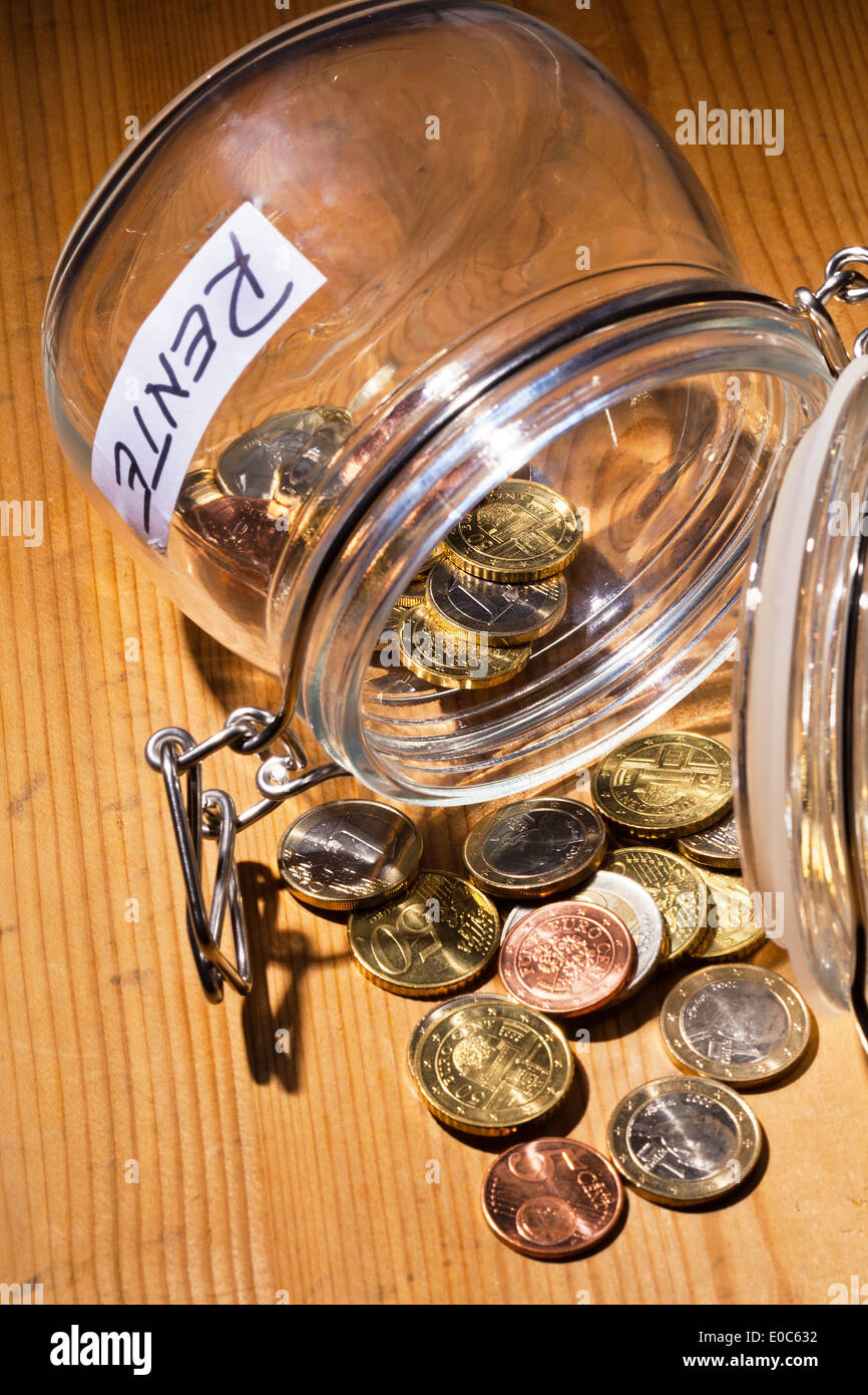 Coins in a jam jar Stock Photo - Alamy