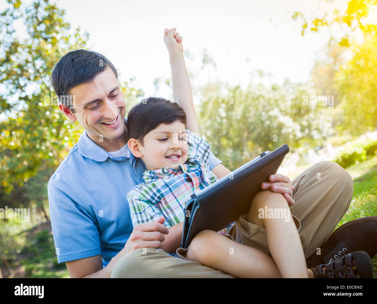Father and son looking into computer hi-res stock photography and ...