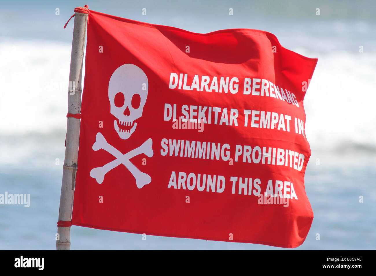 Red Flag on the Sand Beach with No Swimming Sign Stock Photo - Alamy