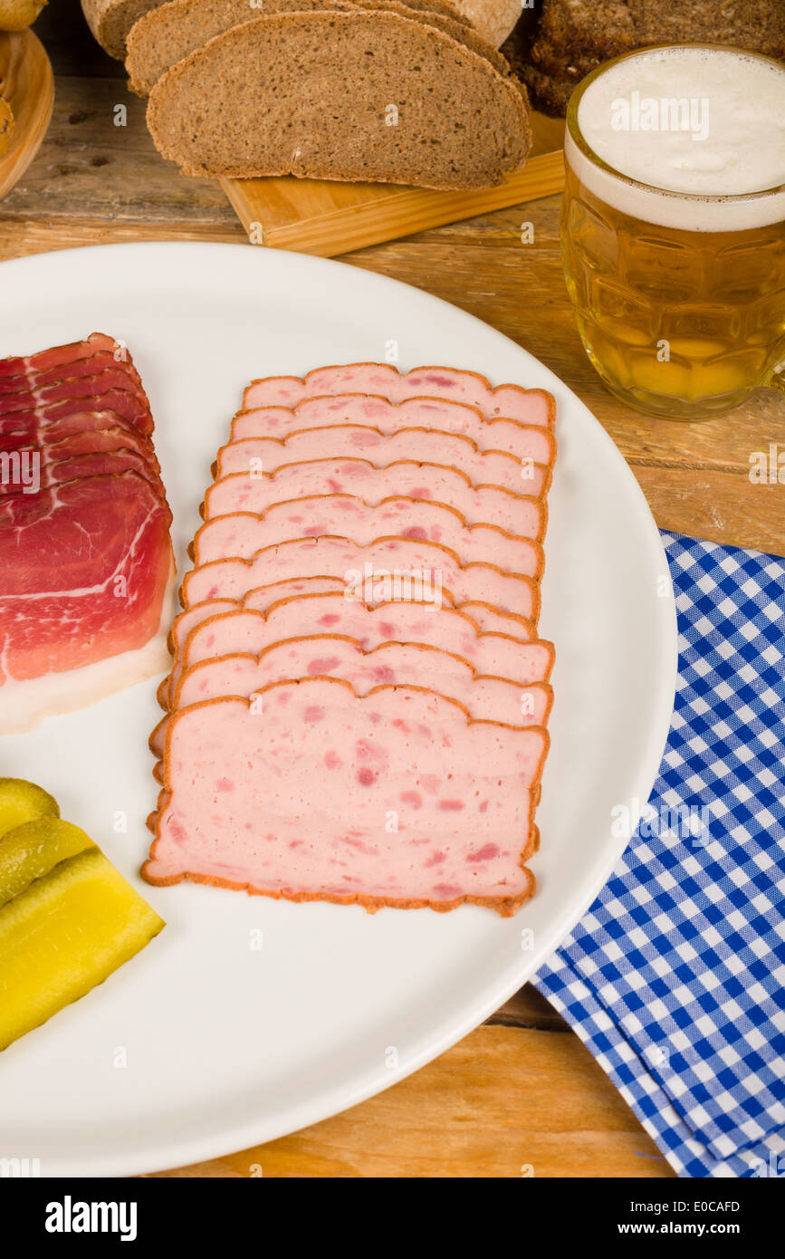 Cold meat, pickles, whole wheat bread and beer, a traditional German ...