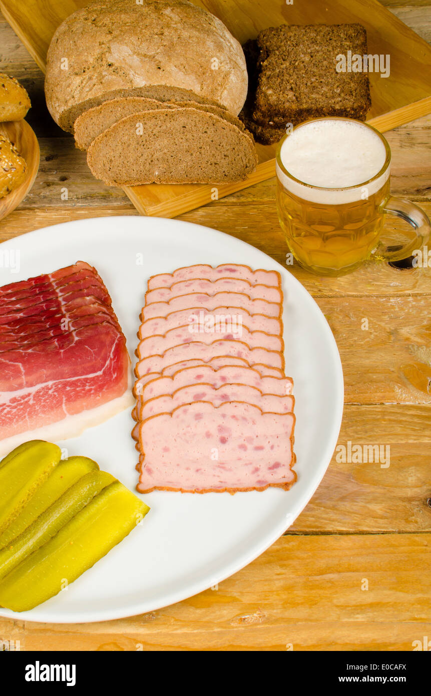 Cold meat, pickles, whole wheat bread and beer, a traditional German ...