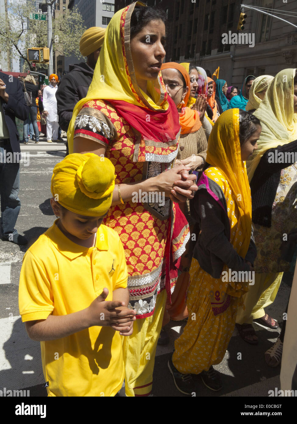 The 27th annual Sikh Day Parade on Madison Avenue in NYC, 2014. Mother and son pray as float ...