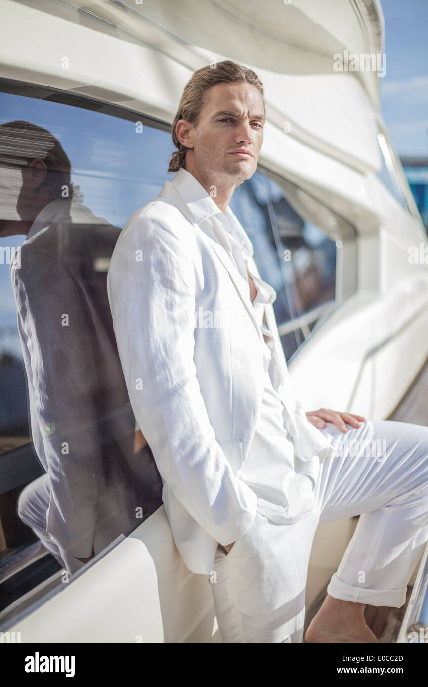 Male model on a superyacht, in a marina, dressed all white Stock Photo ...