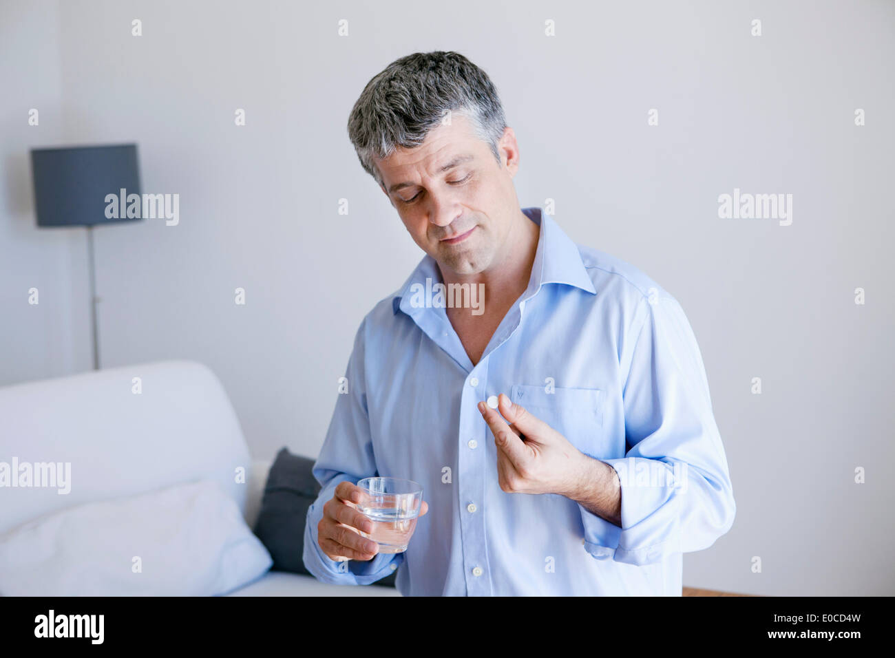 Man taking medication Stock Photo - Alamy
