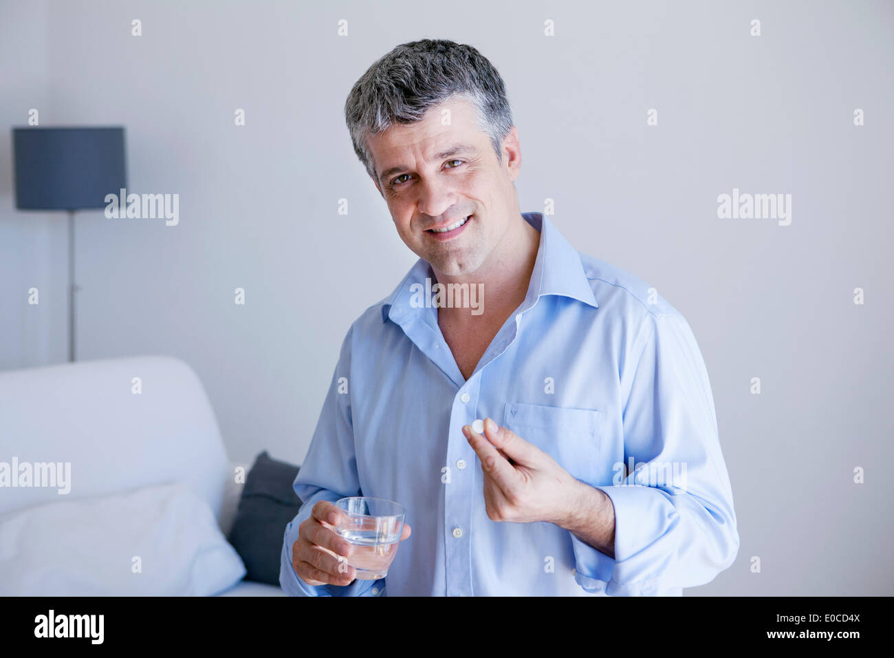 Man taking medication Stock Photo - Alamy