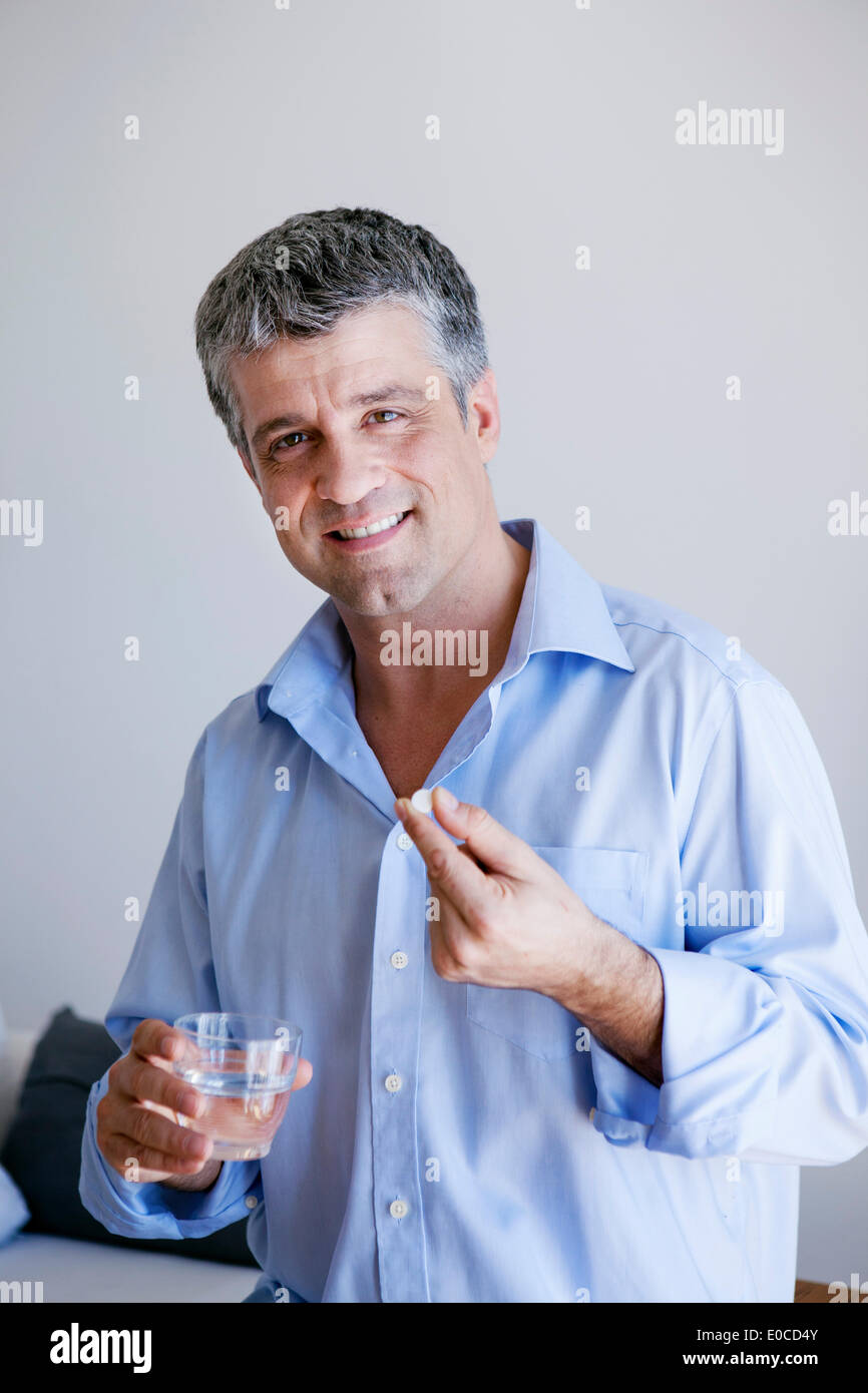 Man taking medication Stock Photo - Alamy