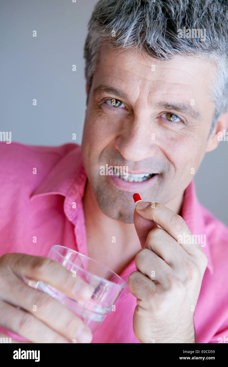 Man taking medication Stock Photo - Alamy