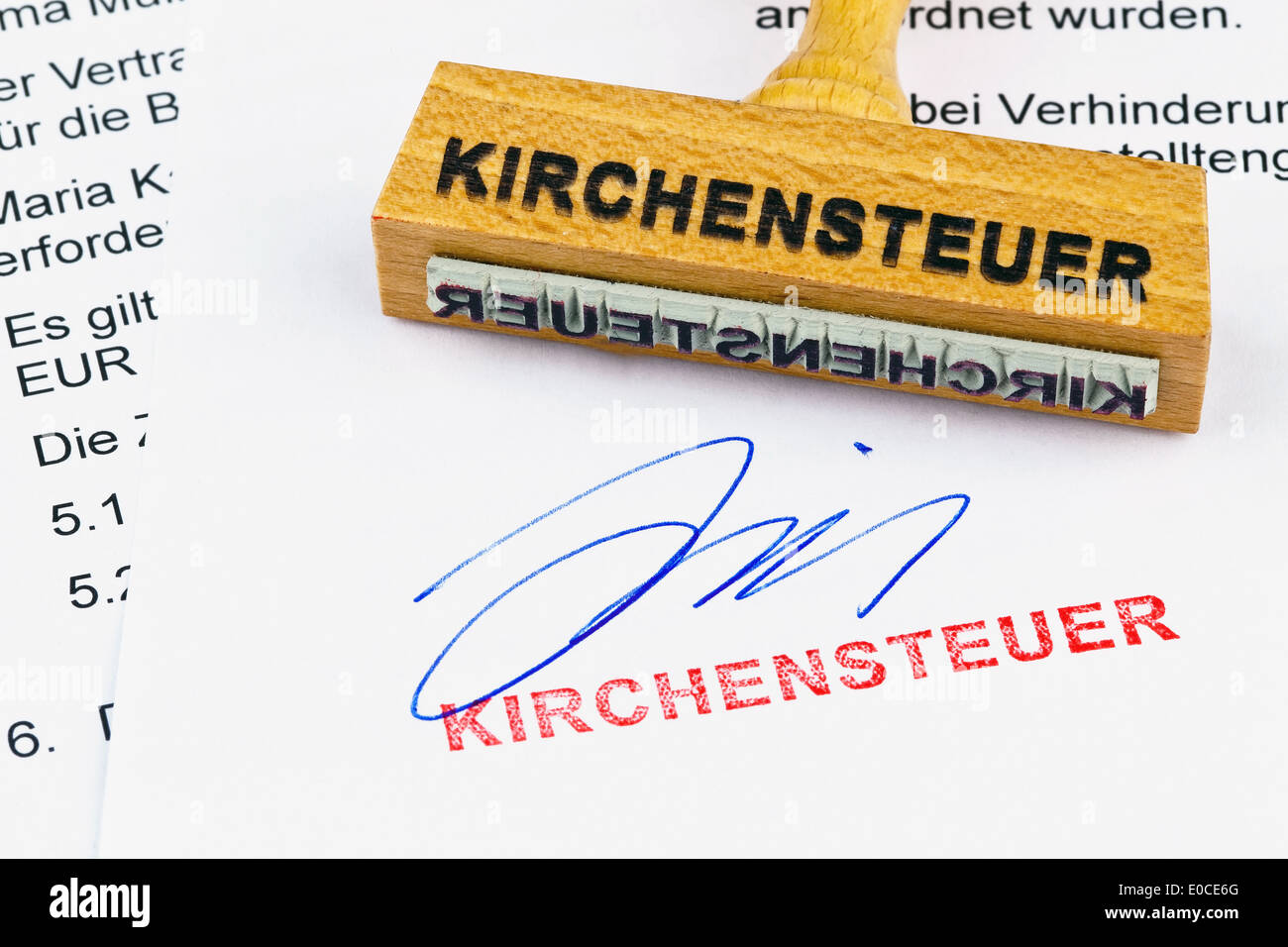 A stamp of wood lies on a document. Label Church-expensive, Ein Stempel ...
