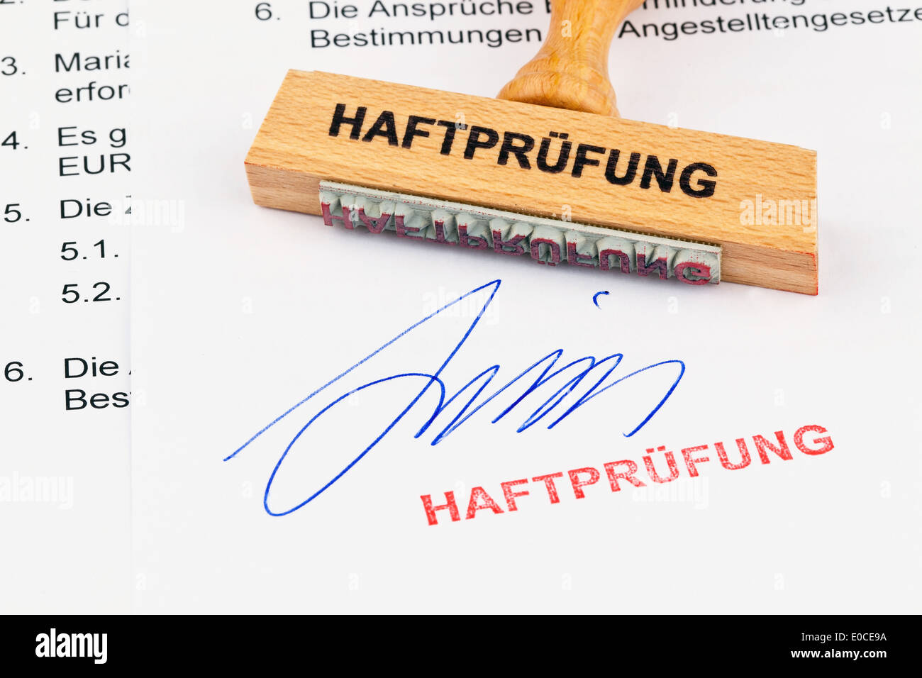 A stamp of wood lies on a document. Label Custody check, Ein Stempel ...
