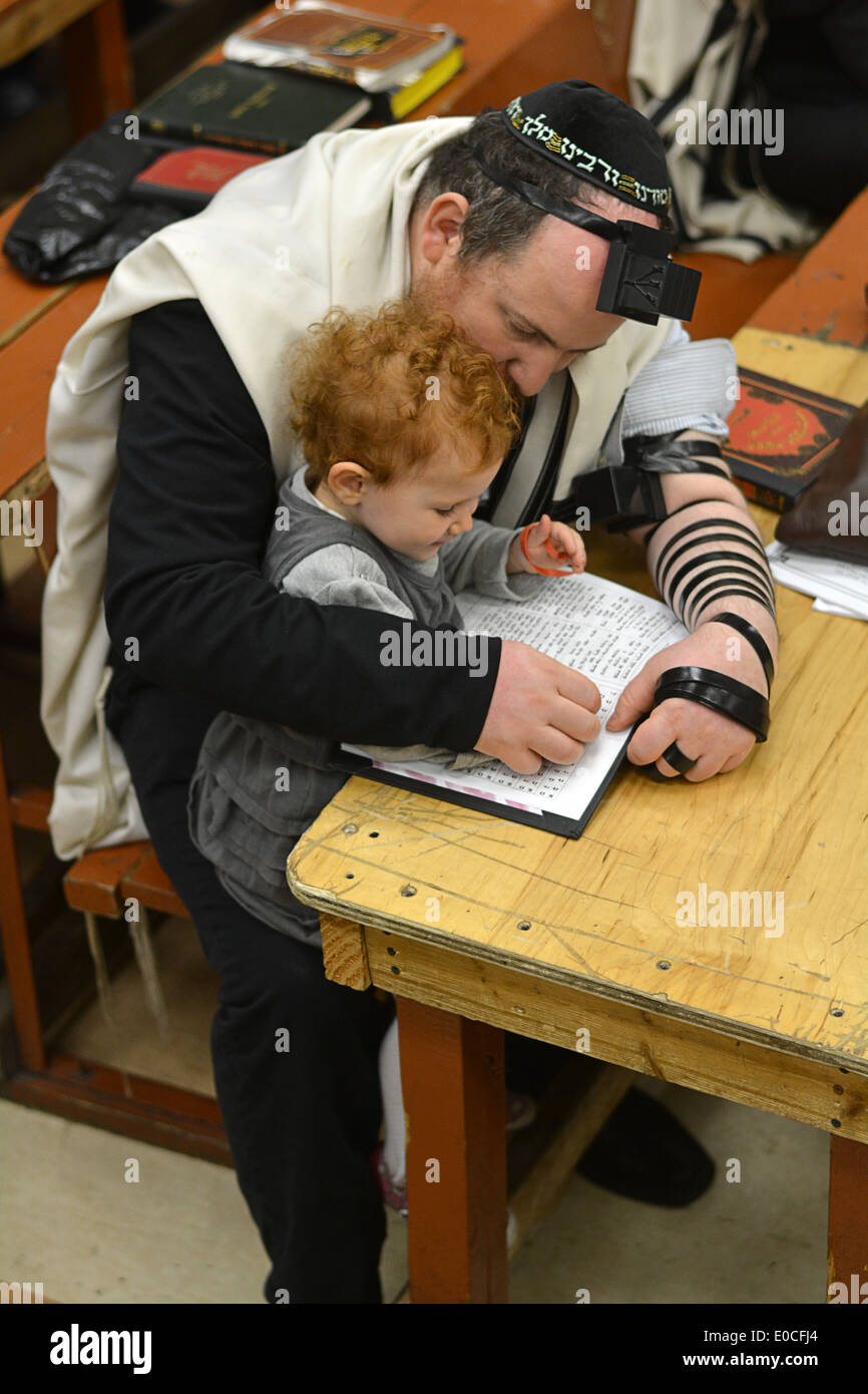 Religious Jewish father and child reading in the synagogue Stock Photo ...
