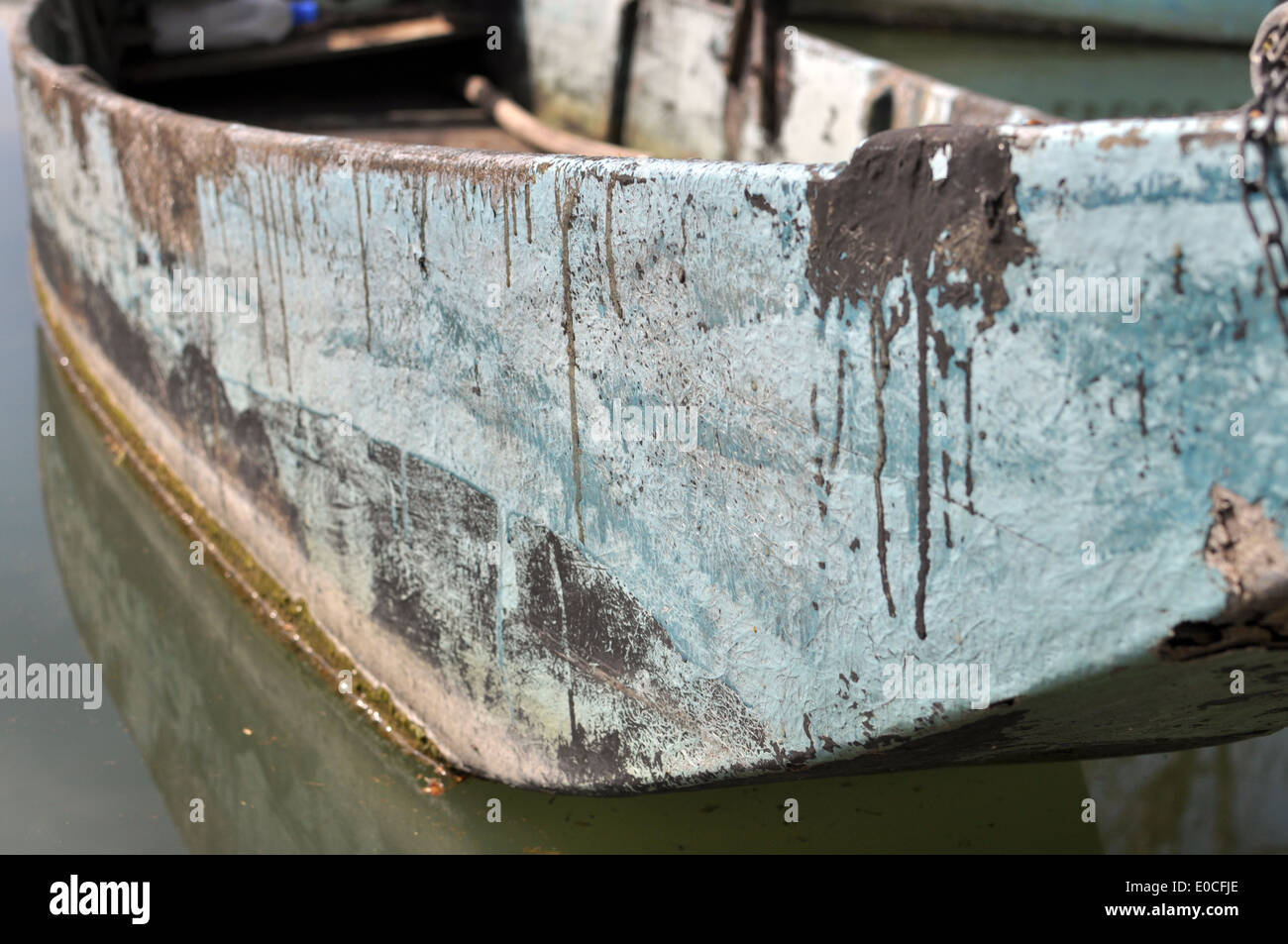 Close up of the front of a old blue painted fishing boat in the harbor ...