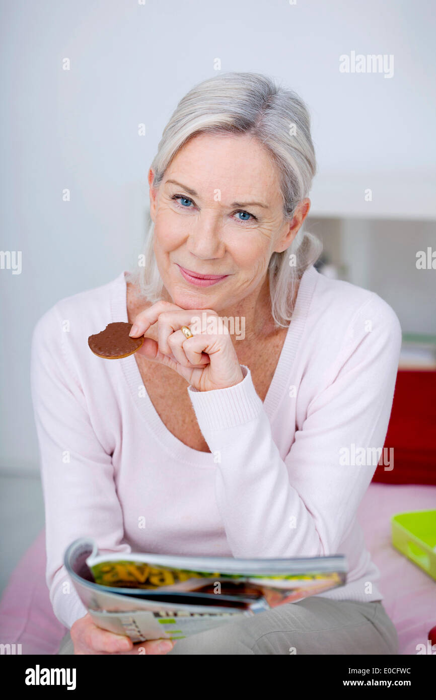 Elderly lady eating biscuits hi-res stock photography and images - Alamy
