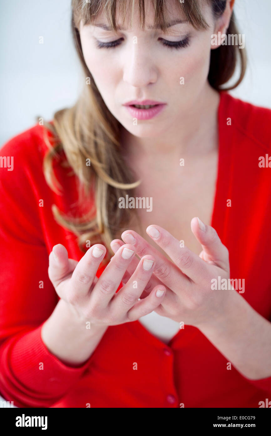 Woman with painful hand Stock Photo - Alamy