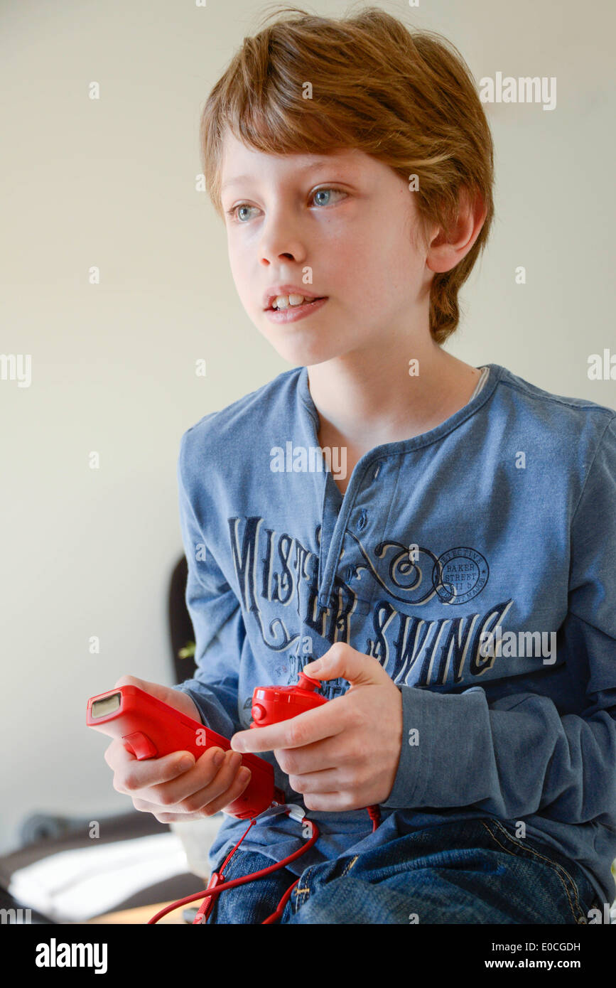 Child playing with video game Stock Photo - Alamy