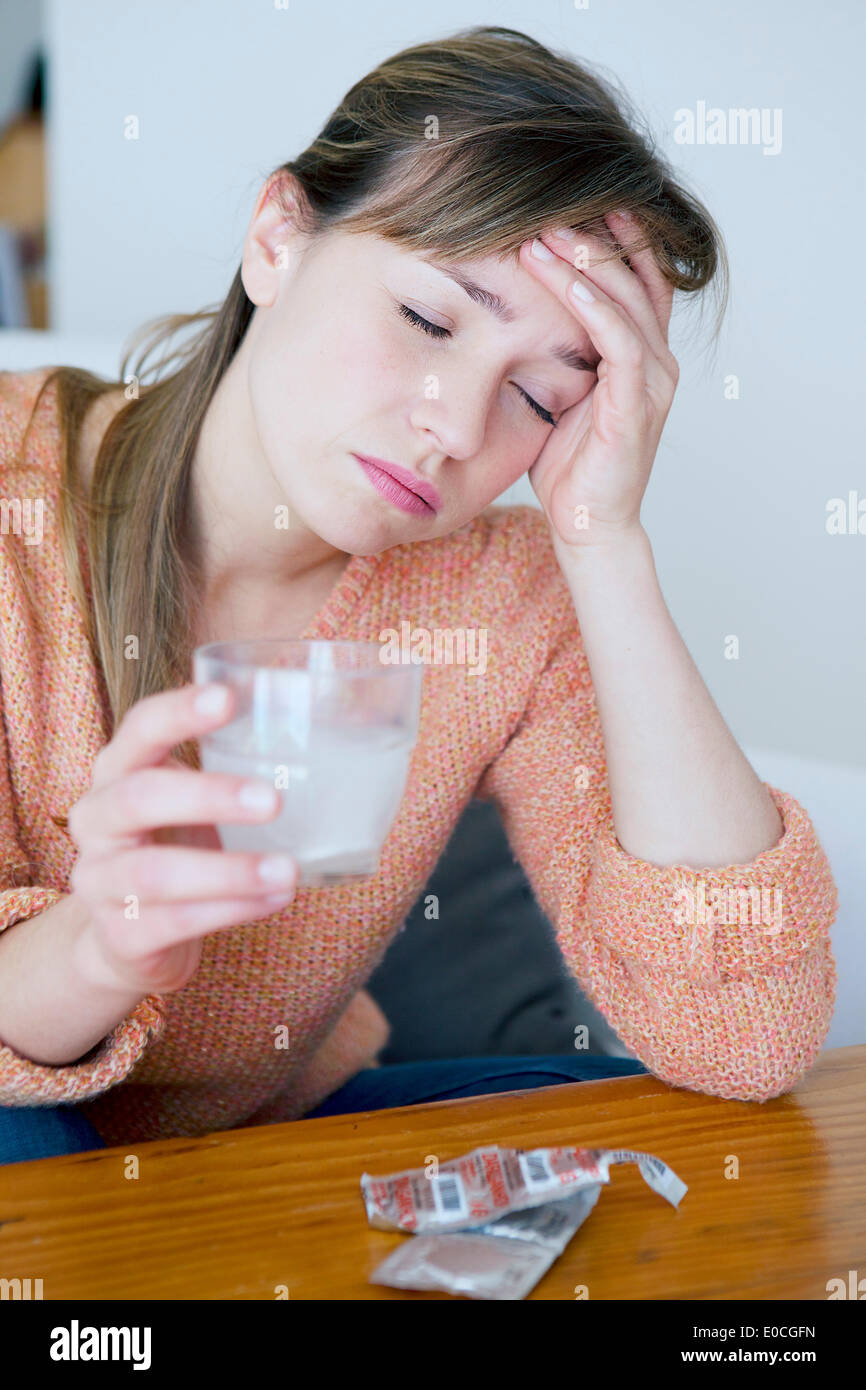 Woman taking medication Stock Photo - Alamy