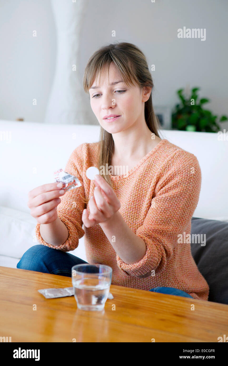 Woman taking medication Stock Photo - Alamy