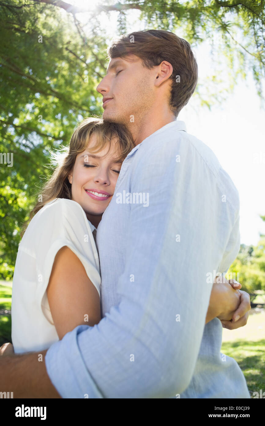 Cute couple hugging in the park Stock Photo - Alamy