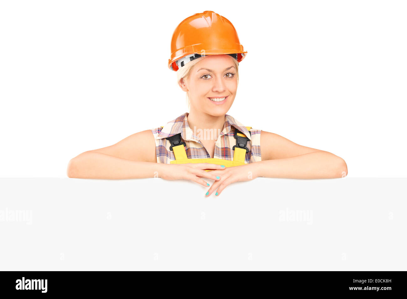 Female construction worker posing behind blank panel Stock Photo - Alamy