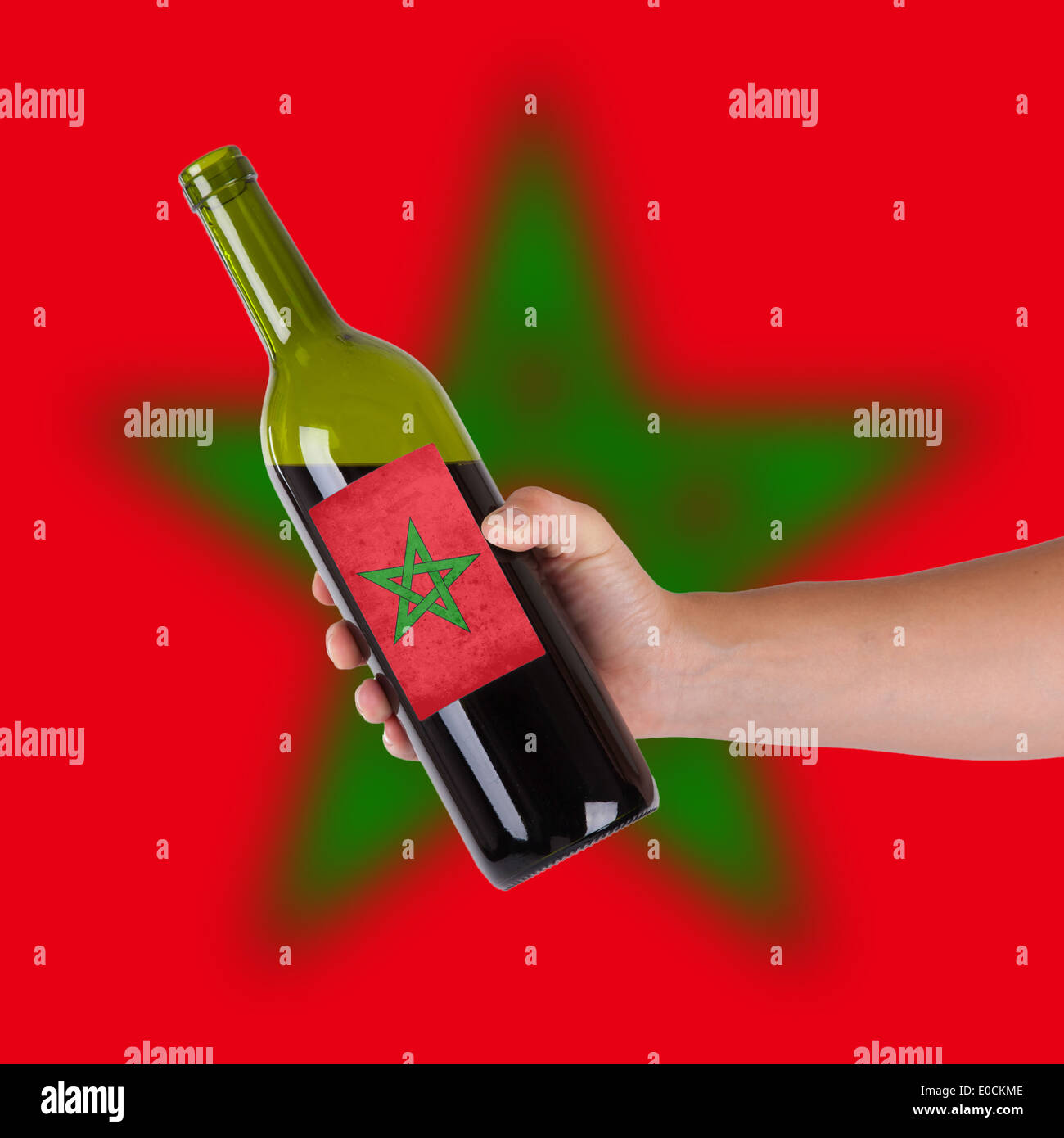Hand holding a bottle of red wine label of Morocco isolated on white ...