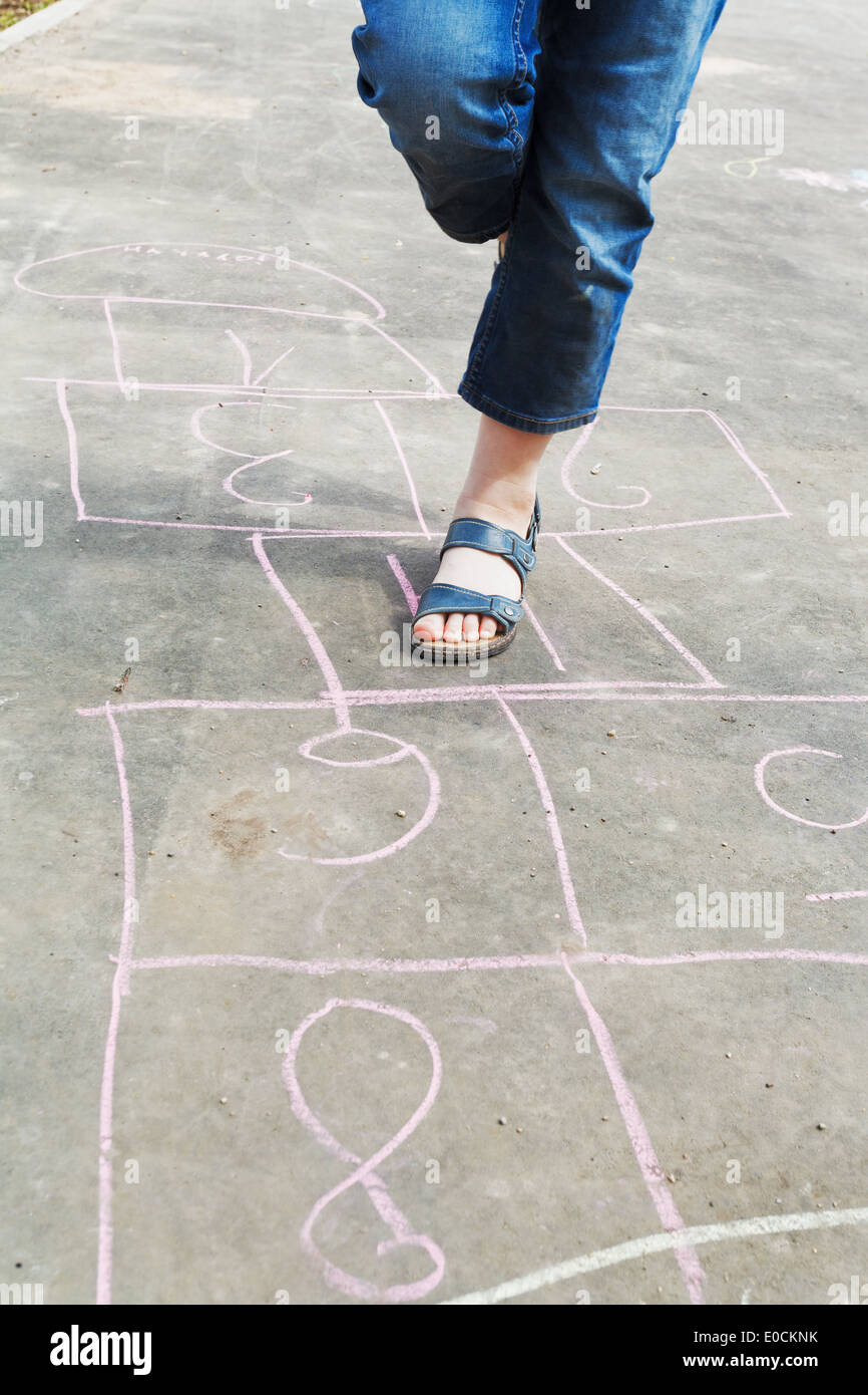 girl hops in hopscotch outdoors in sunny day Stock Photo - Alamy