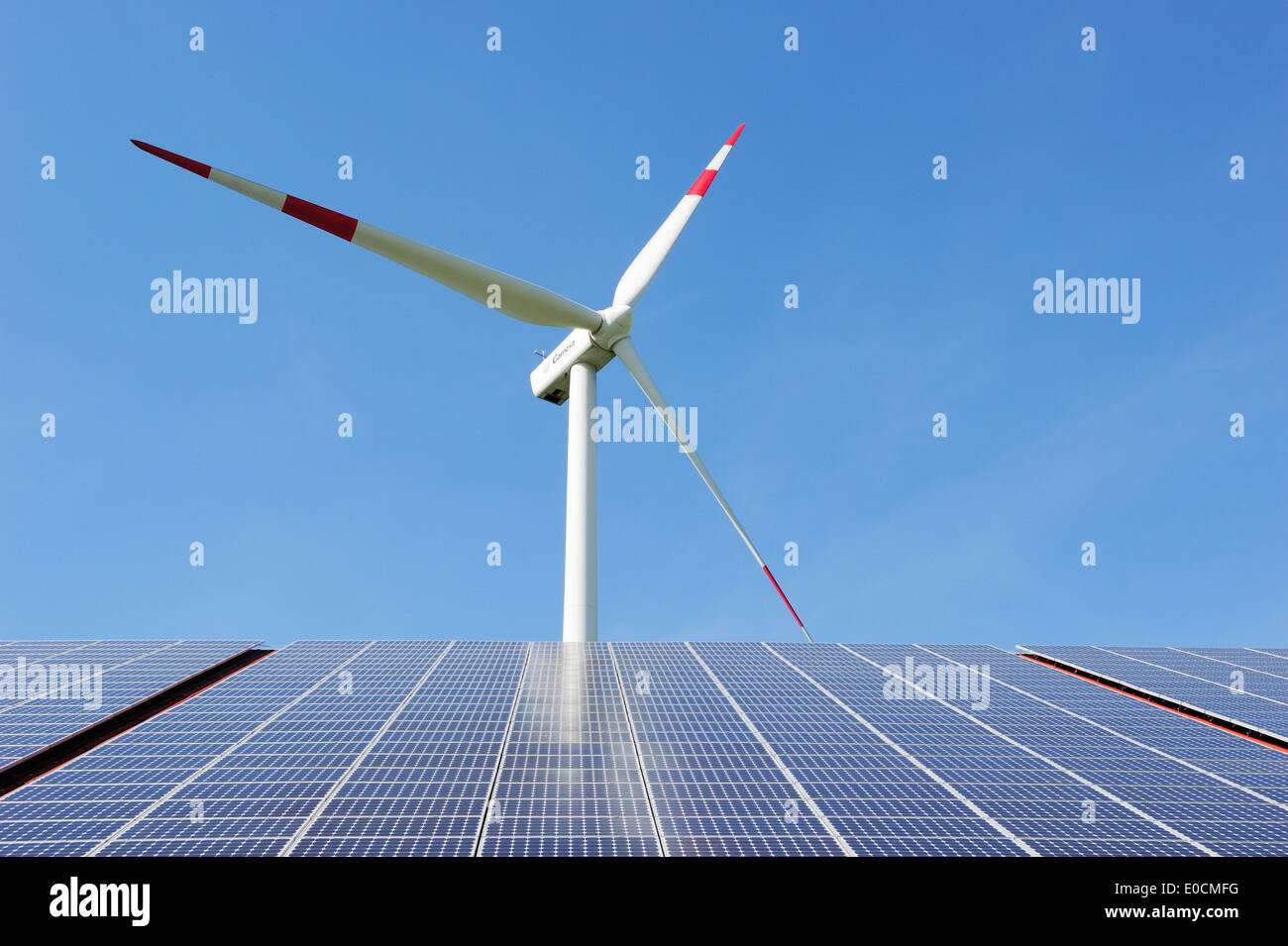 Wind power plant rising above solar panels, Ulm, Baden-Wuerttemberg ...