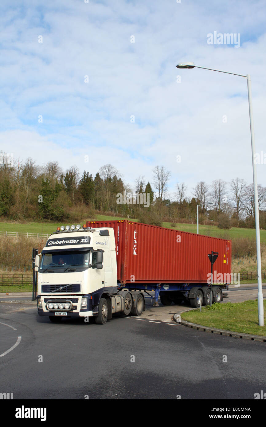 An unmarked Volvo truck with a Textainer container entering a ...