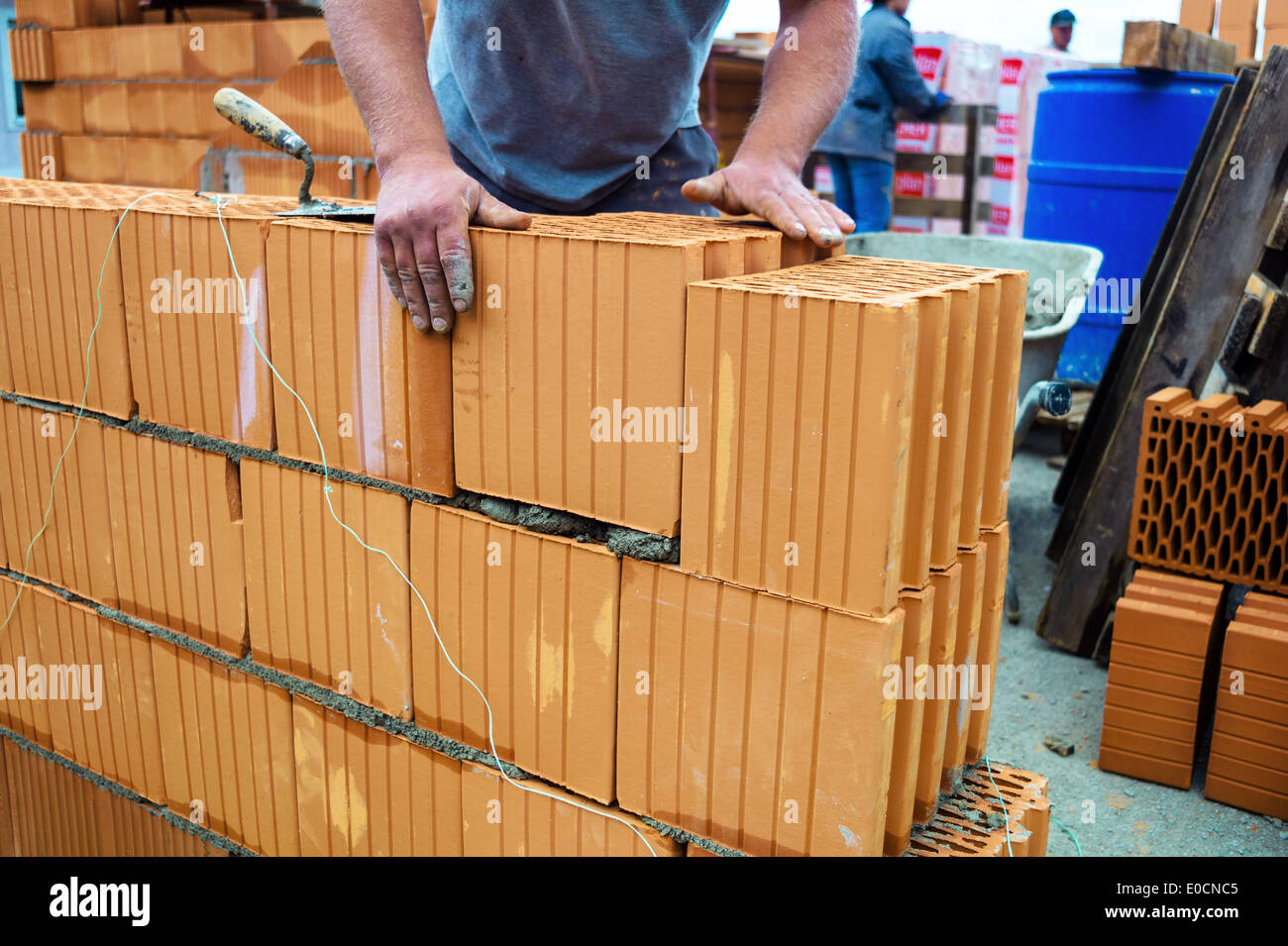 Construction worker with the wall of a shell in massive construction ...