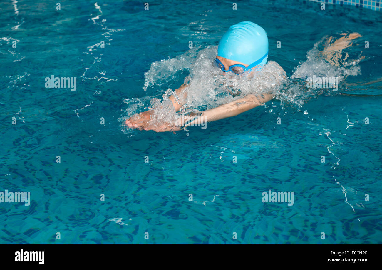 Child swimmer in swimming pool. Blue color swimming pool Stock Photo ...