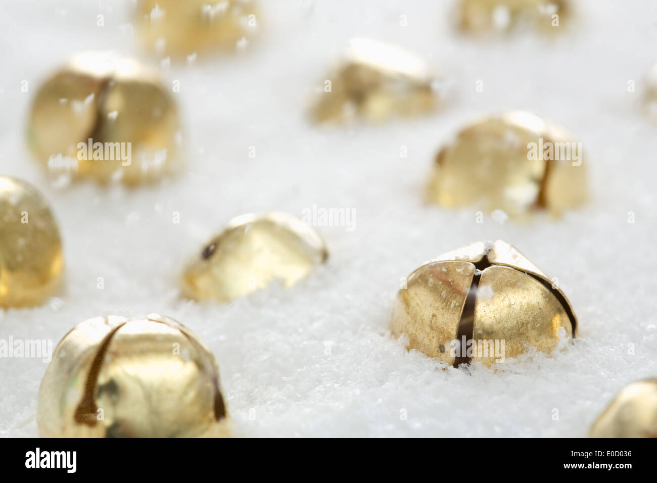 Golden jingle bells in snow Stock Photo - Alamy