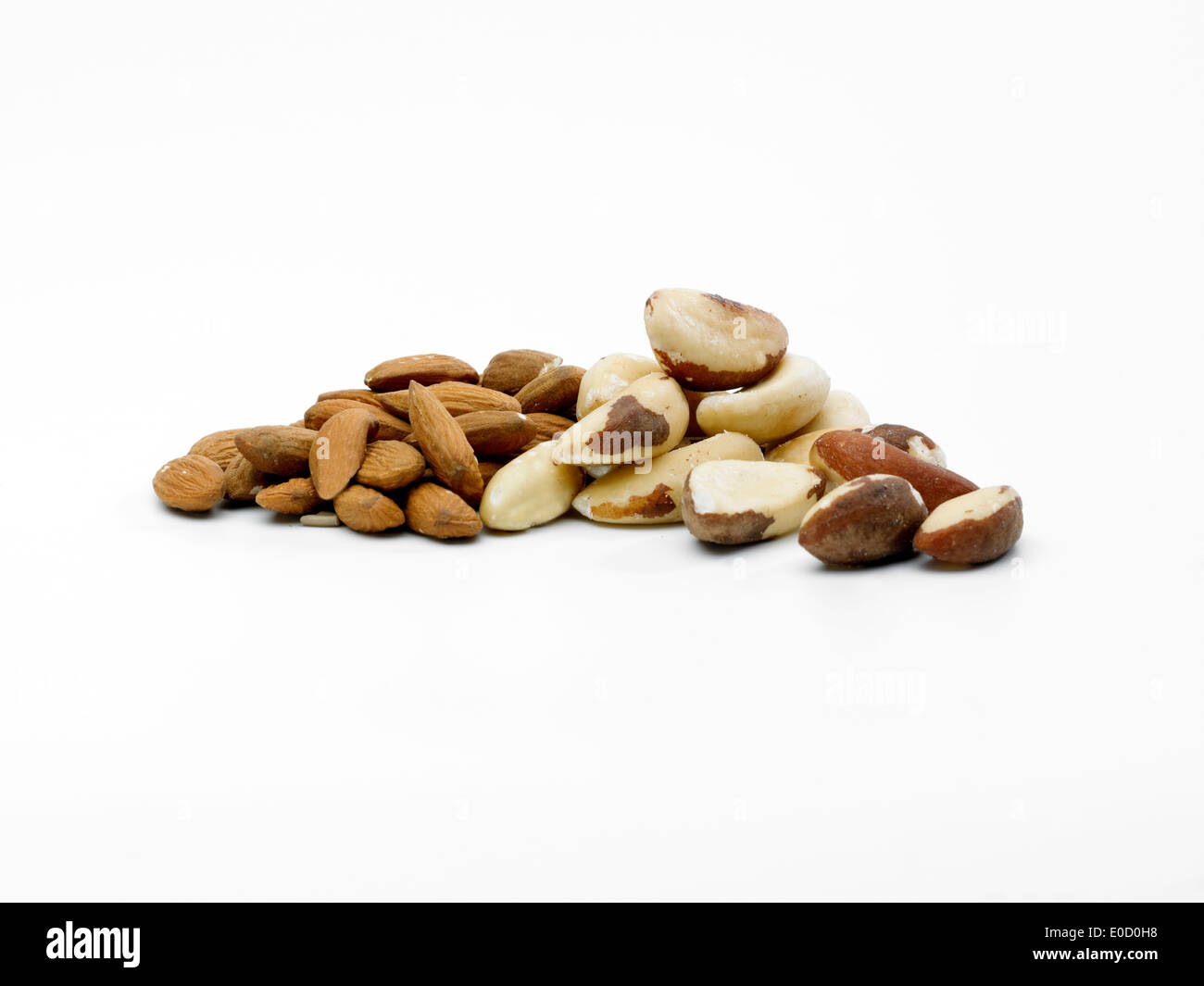 a selection of shelled Brazil and Almonds nuts on a white background ...