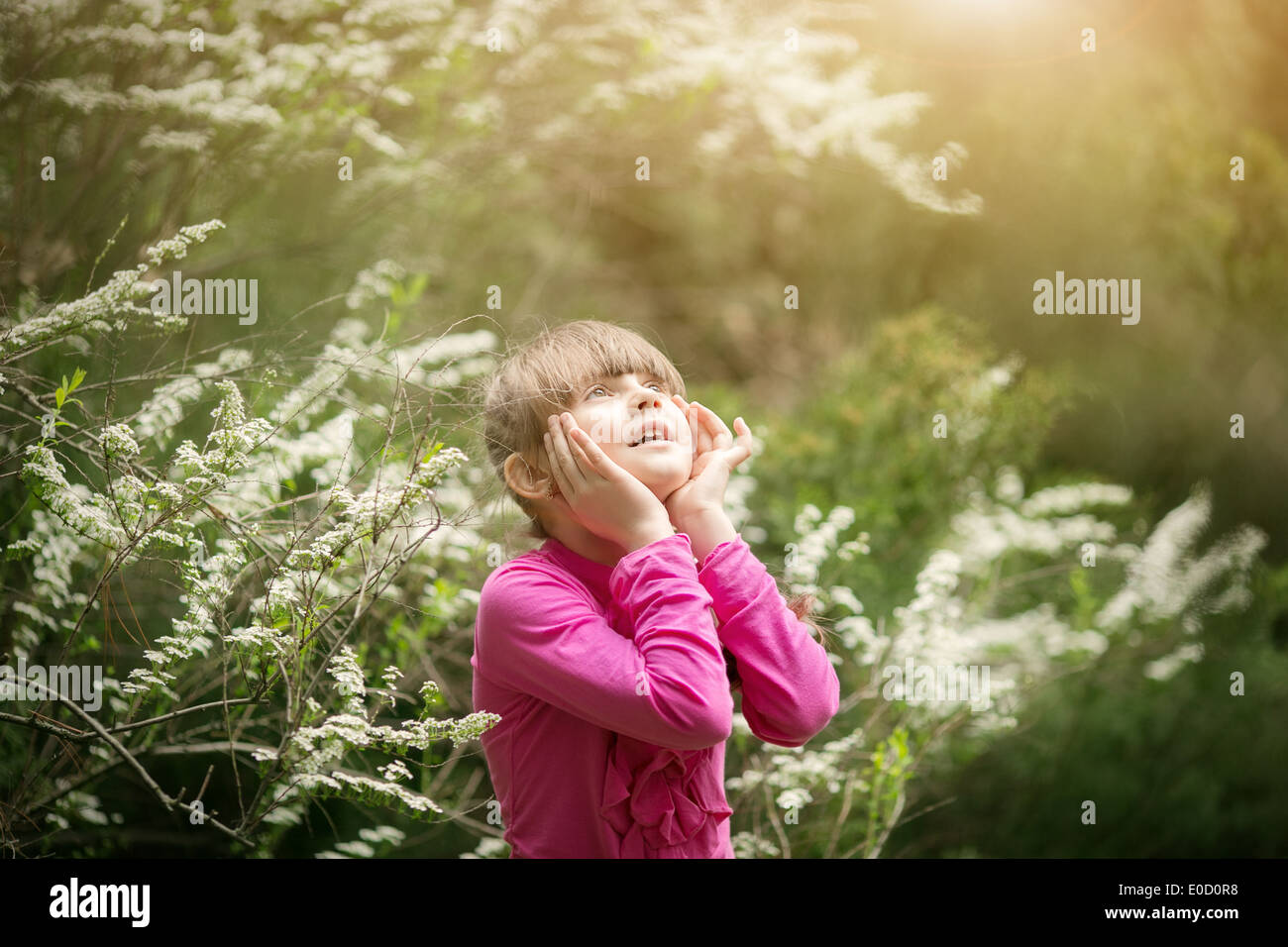 beautiful gentle girl standing in a lush garden Stock Photo - Alamy