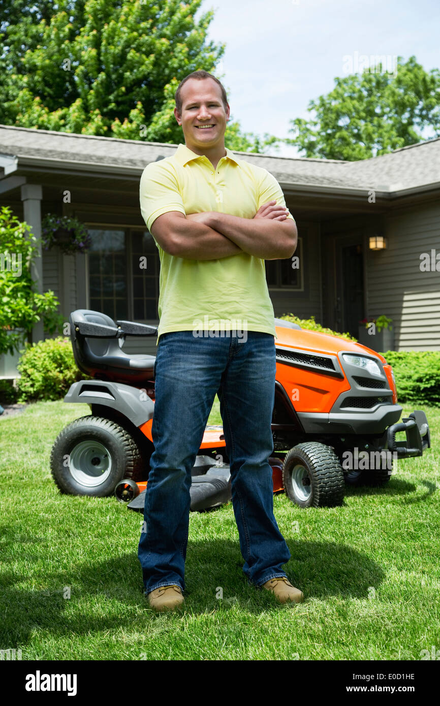 Man riding lawn mower hi-res stock photography and images - Alamy