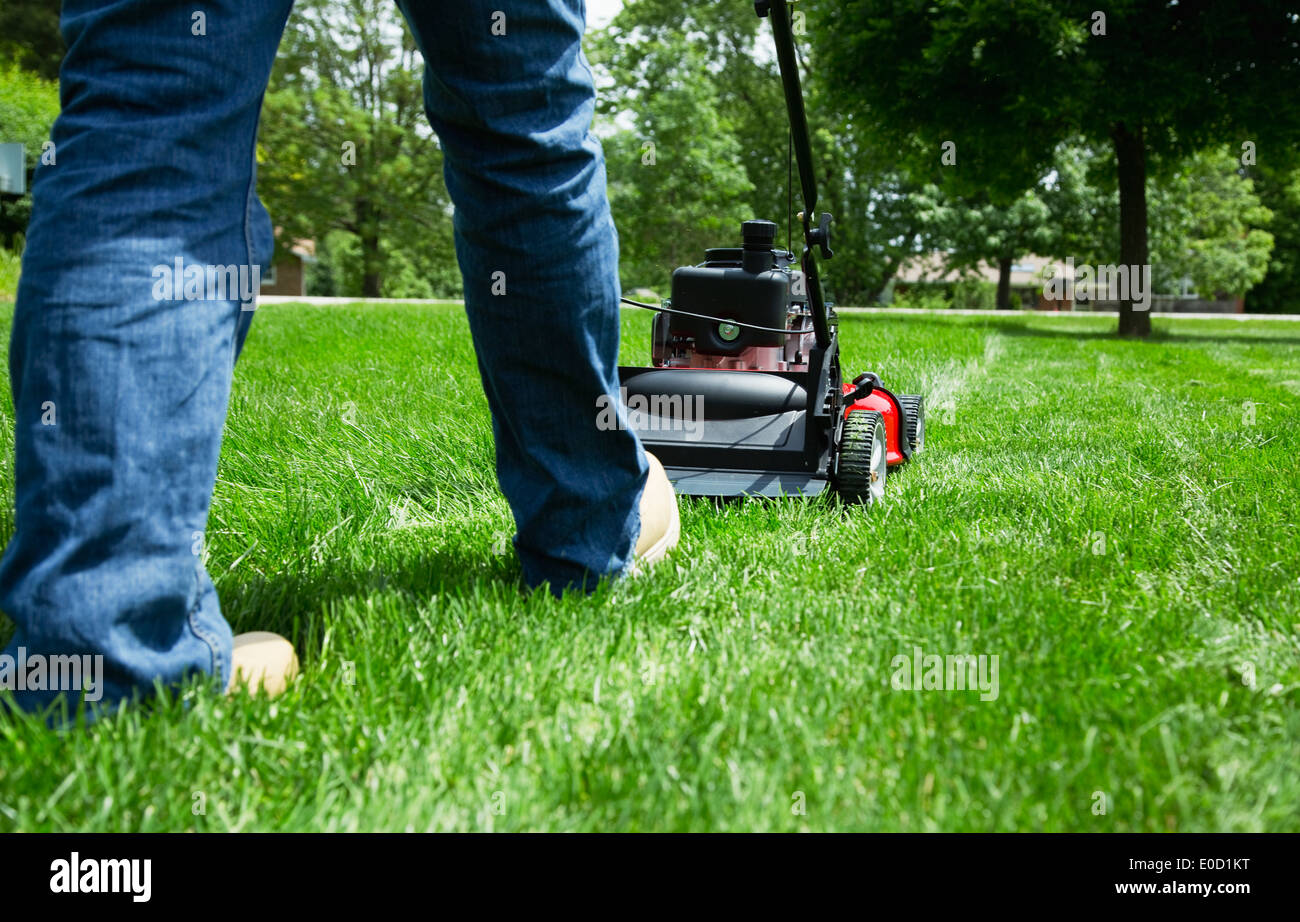 Man mowing lawn Stock Photo - Alamy