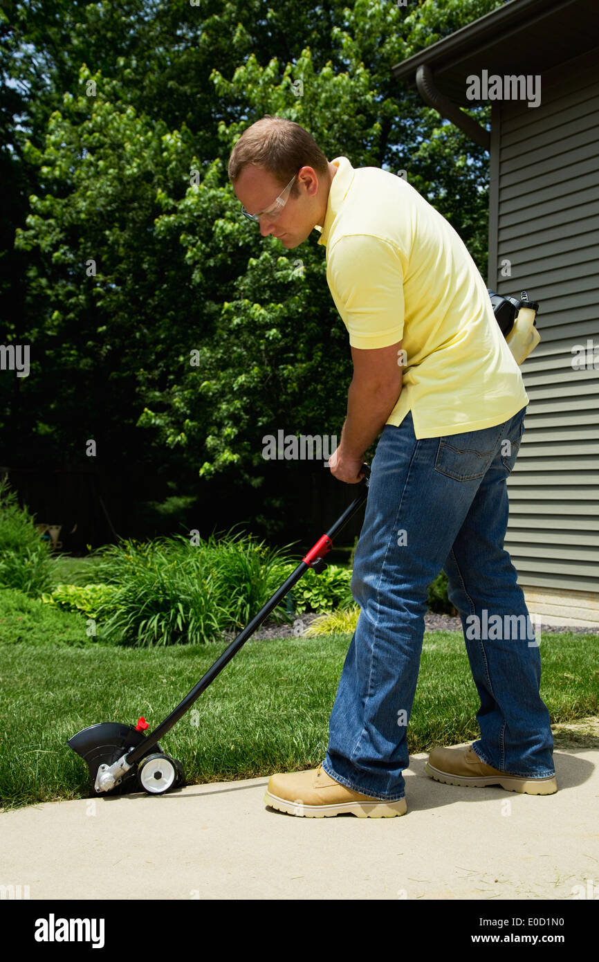 Man mowing grass in back yard Stock Photo - Alamy