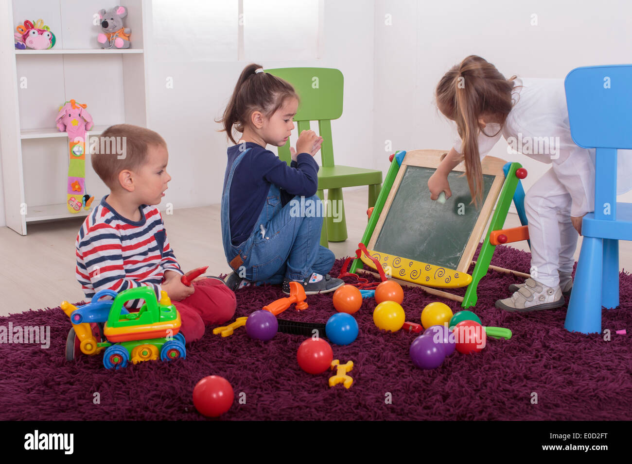 Kids playing in the room Stock Photo - Alamy