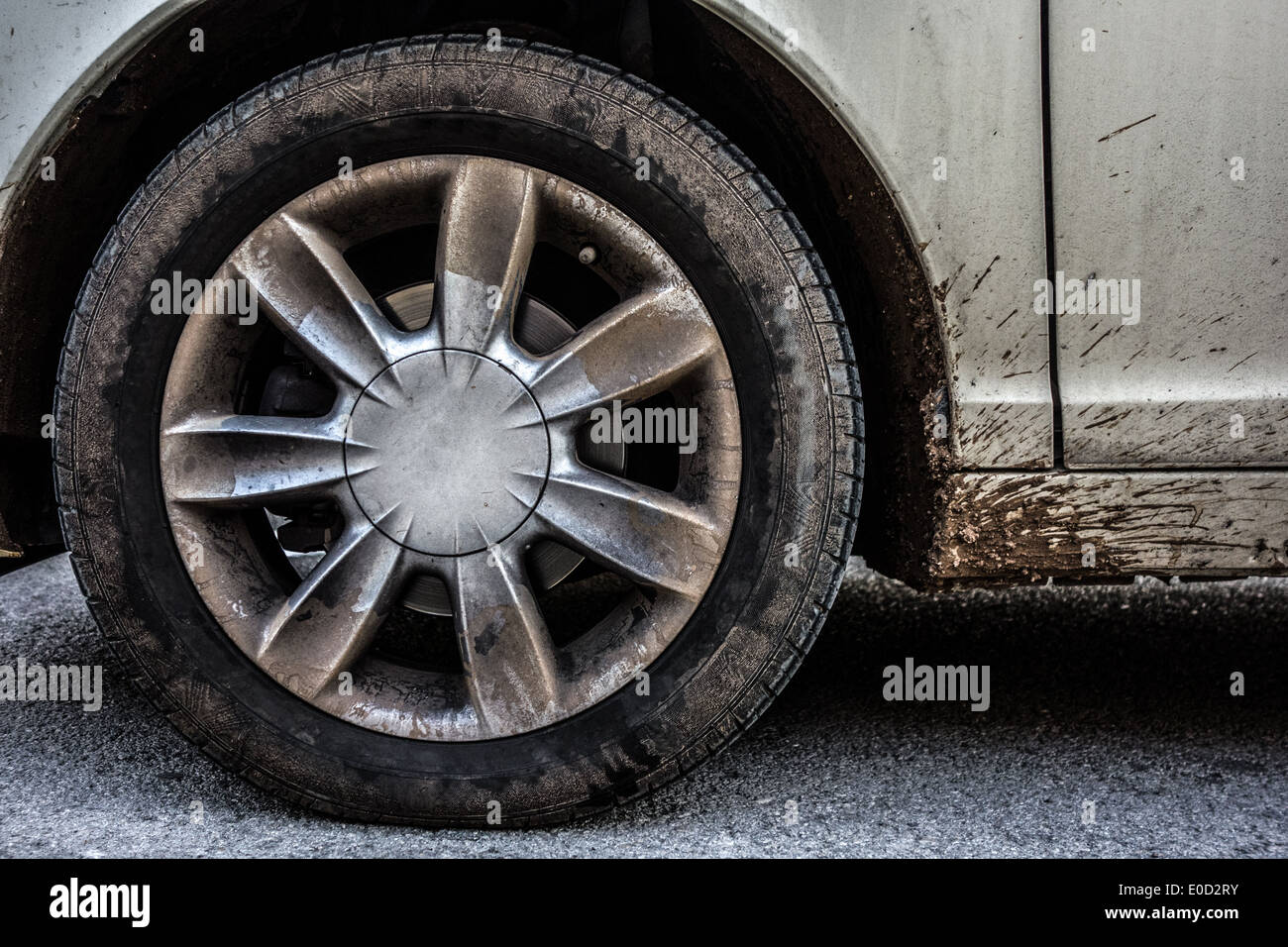 a weathered car wheel with mud and dirt Stock Photo - Alamy