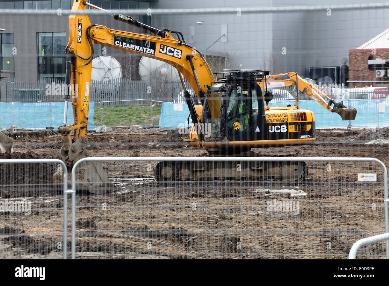 JCB mechanical digger excavating earth on a construction site, Scotland ...