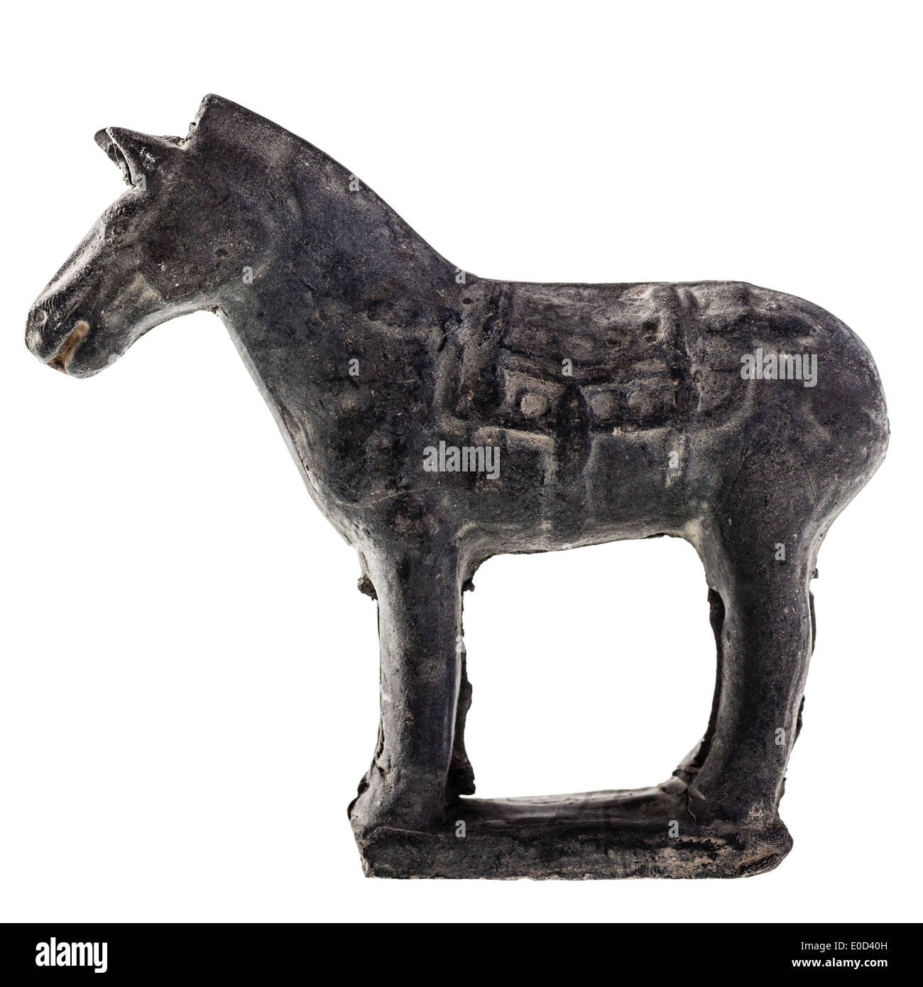 an ancient statuette depicting a horse isolated over a white background ...