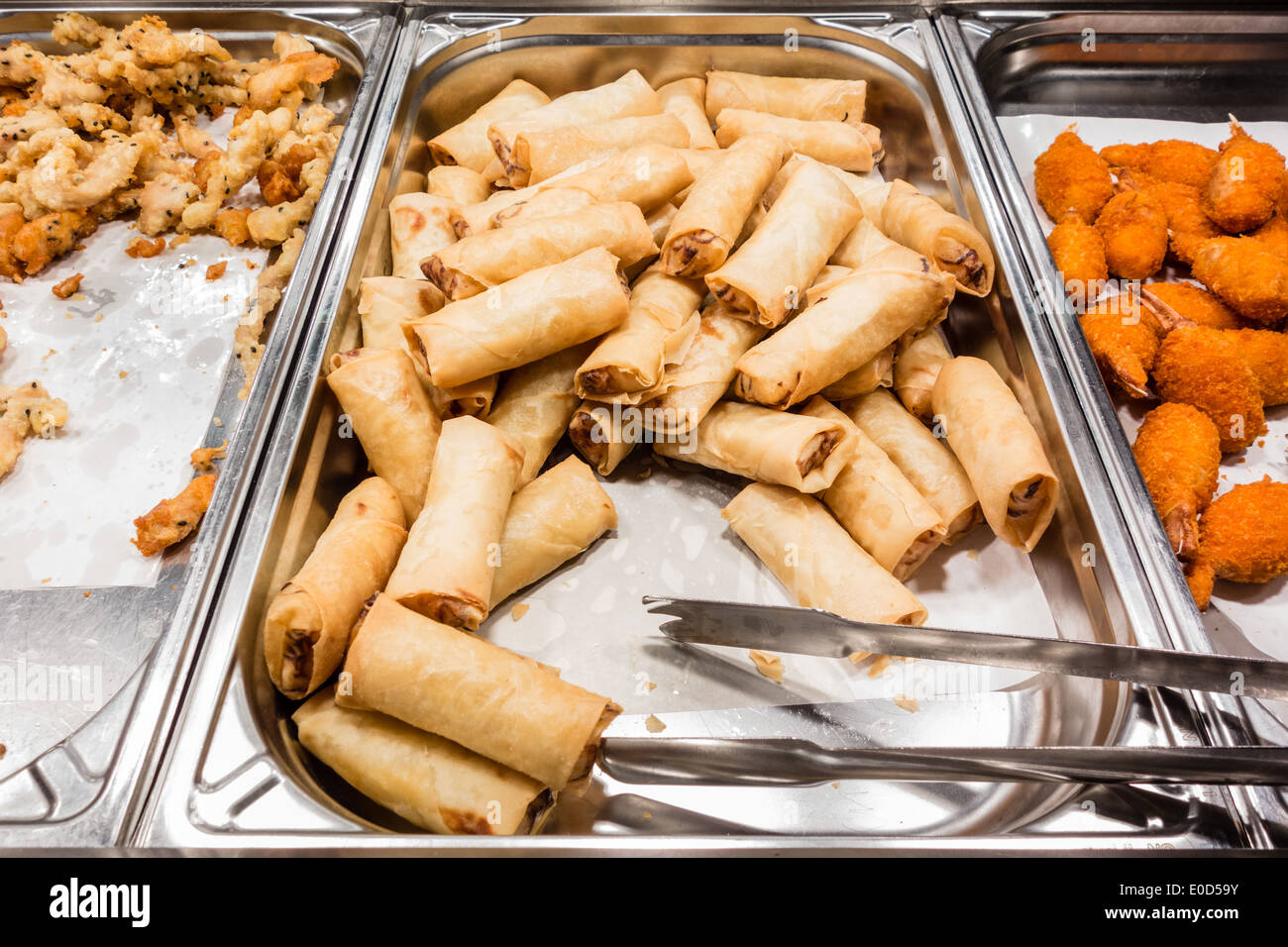 a lot of spring rolls in the food warmer of a self service restaurant ...