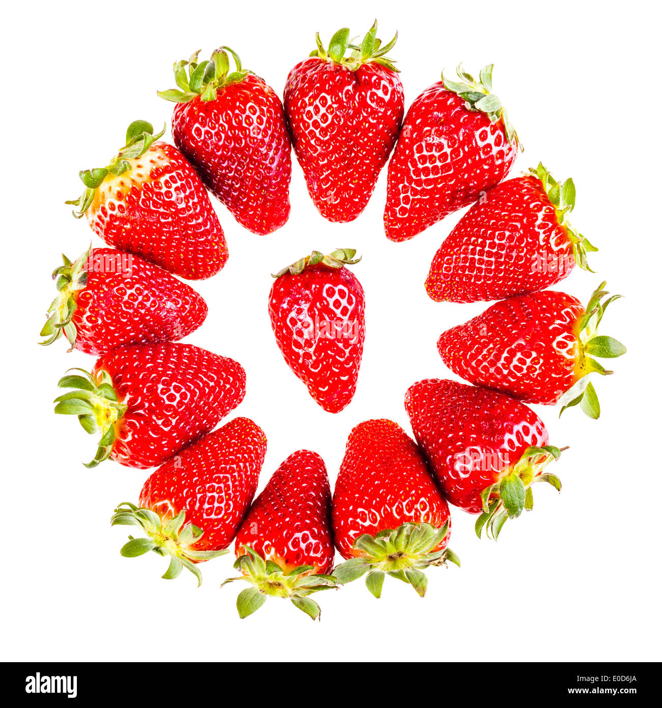 a circle made of ripe red strawberries isolated over a white background ...