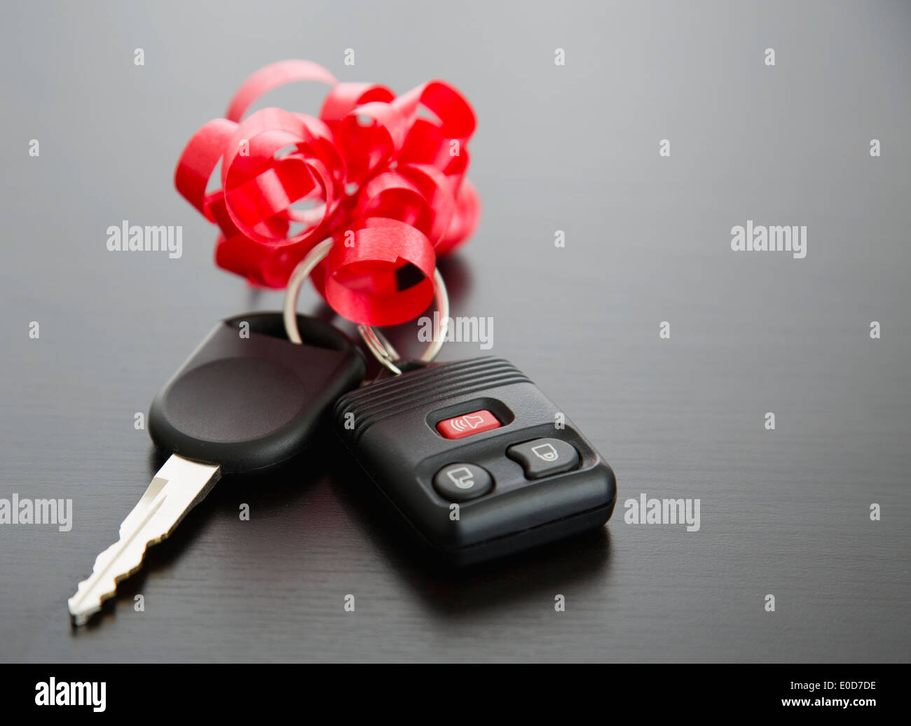 Studio shot of car key with red ribbon Stock Photo - Alamy