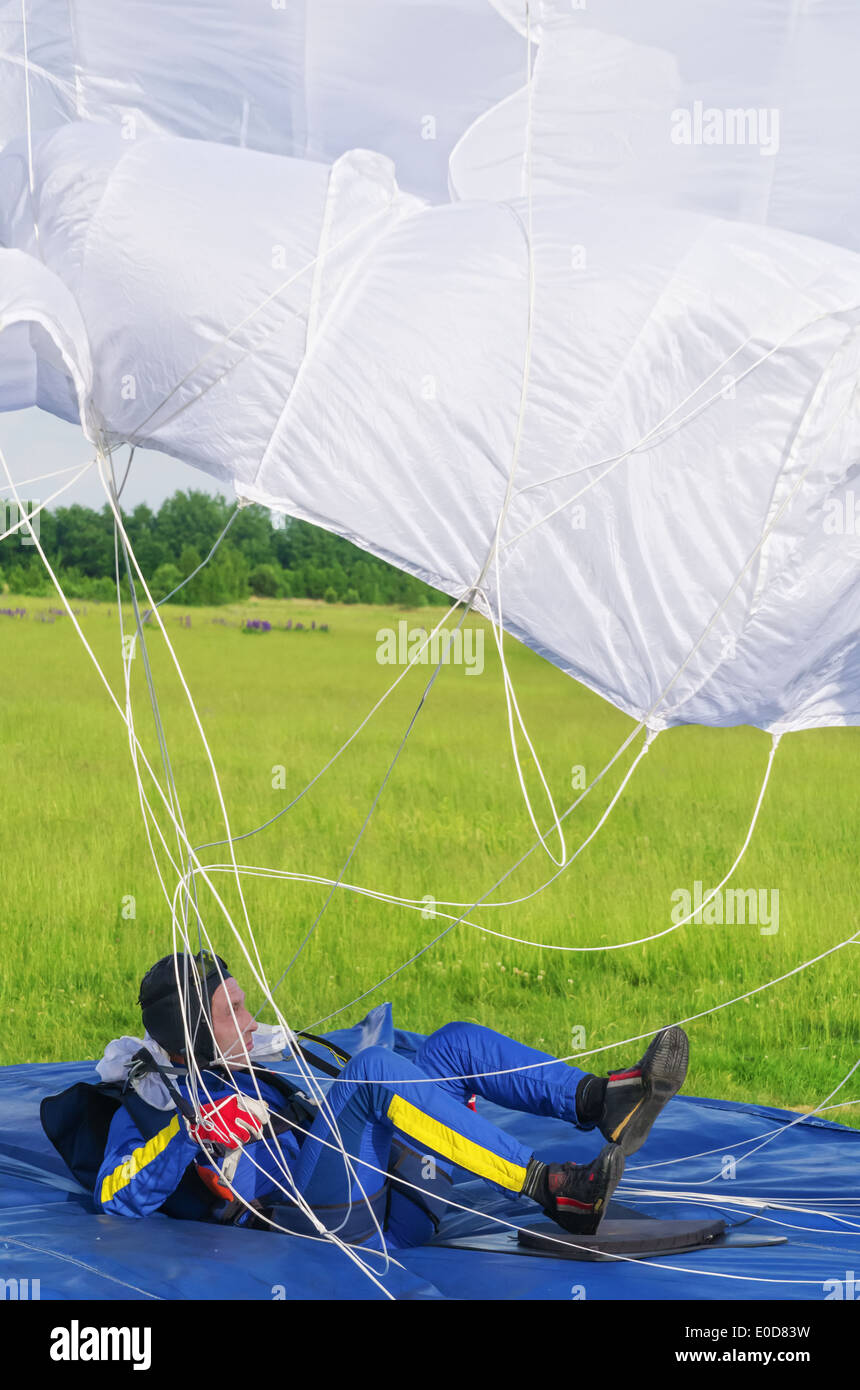 One day with parachutist in airfield. The skydiver lands under the ...