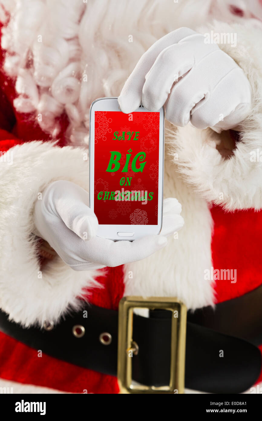 Mid section of Santa holding cell phone Stock Photo - Alamy
