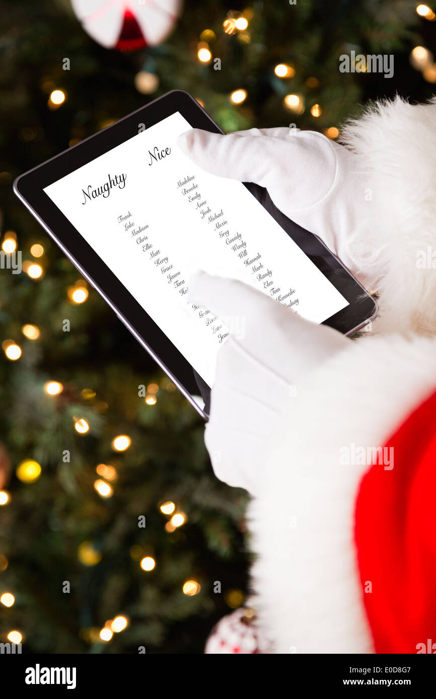 Santa holding digital tablet Stock Photo - Alamy