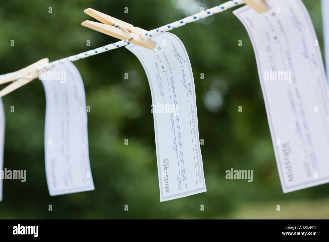 Cheques hanging on clothesline Stock Photo - Alamy