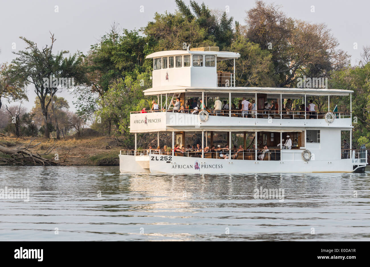 Tourists enjoy an evening riverboat cruise on the 'African Princess' on ...