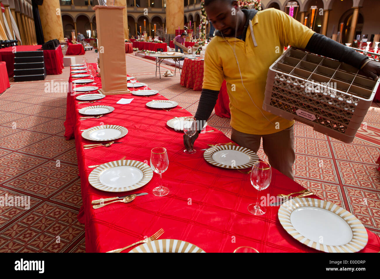 Server preparing dining table for large dinner event Stock Photo - Alamy