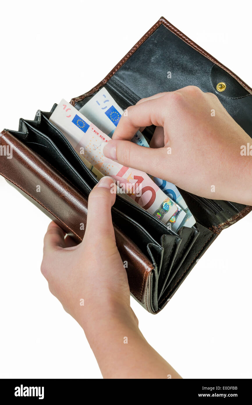 A hand with change purse and euro-bank notes before white background ...