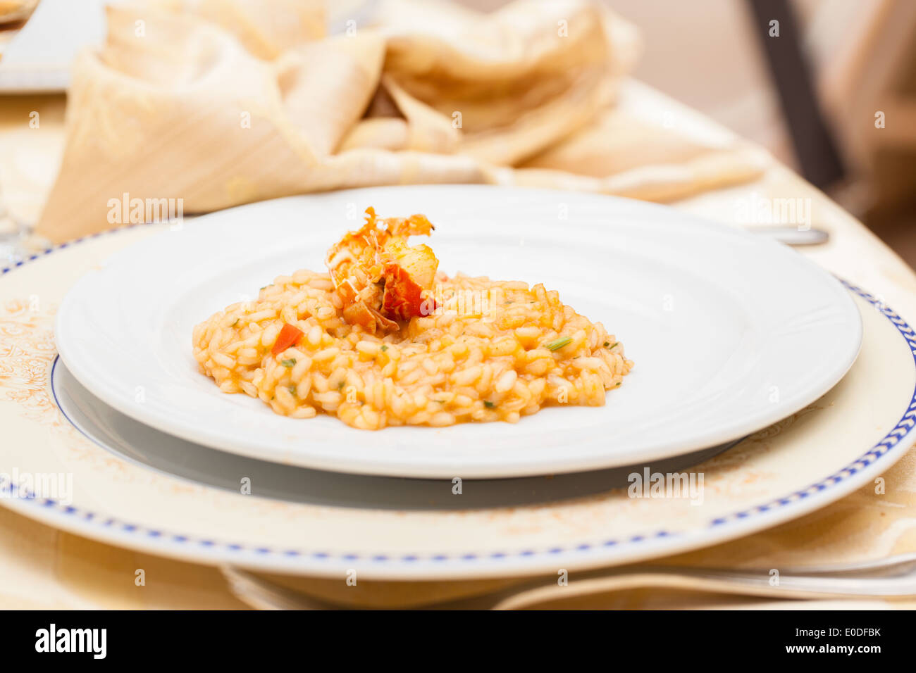 a delicious risotto served in a white plate Stock Photo - Alamy